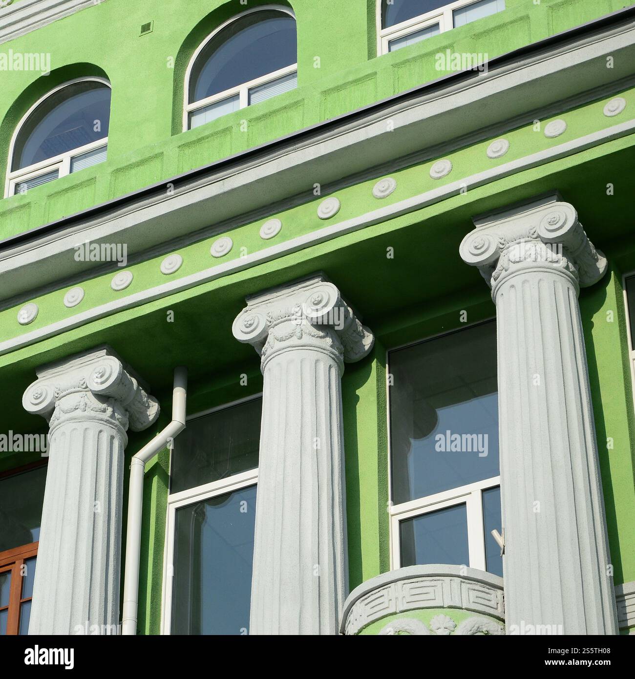 Restored old multi-storey building with antique columns, painted in ...