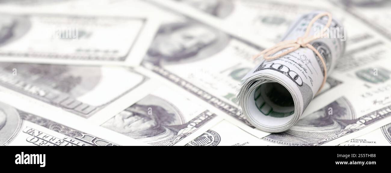 US dollars rolled up and tightened with band lies on a lot of american ...