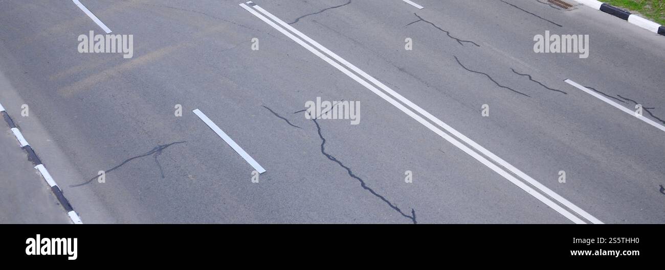 Damaged bad asphalt road with potholes. Patch repair of asphalt. Bad ...