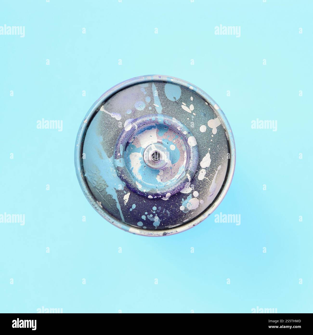 Used spray can with blue paint drips lie on texture background of ...