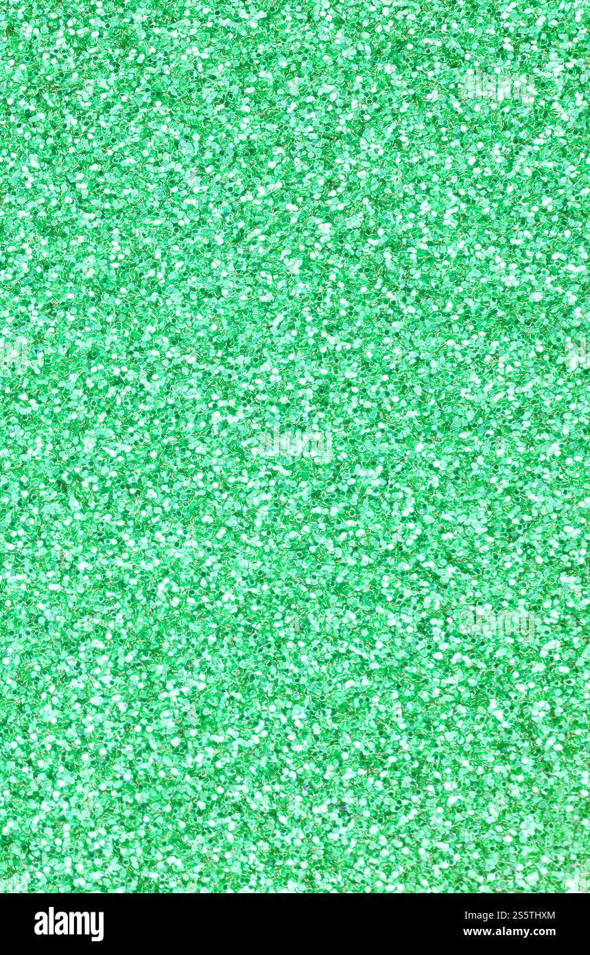 A huge amount of green decorative sequins. Background image with shiny ...