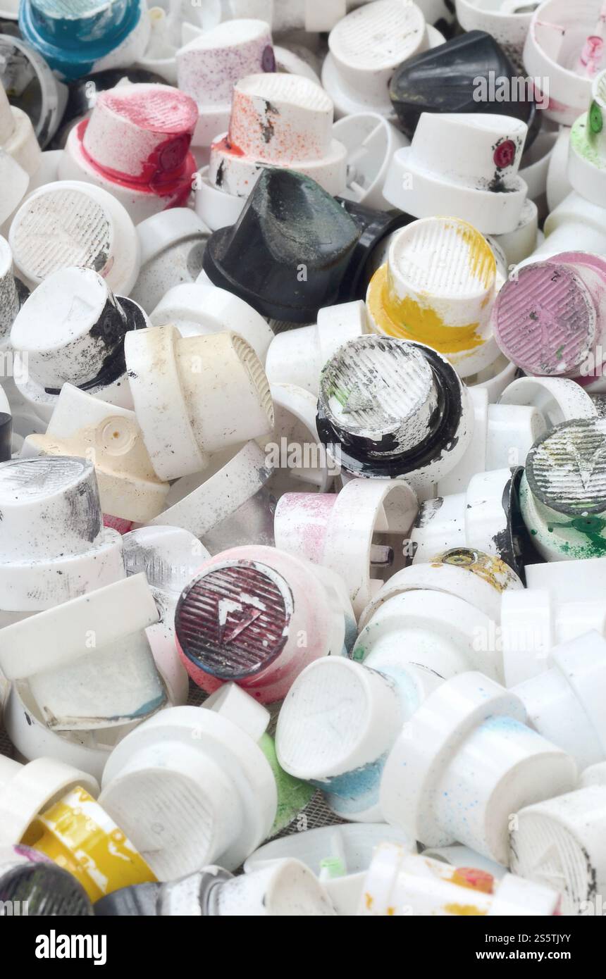 A large number of caps from cans of aerosol paint for graffiti. Smeared ...