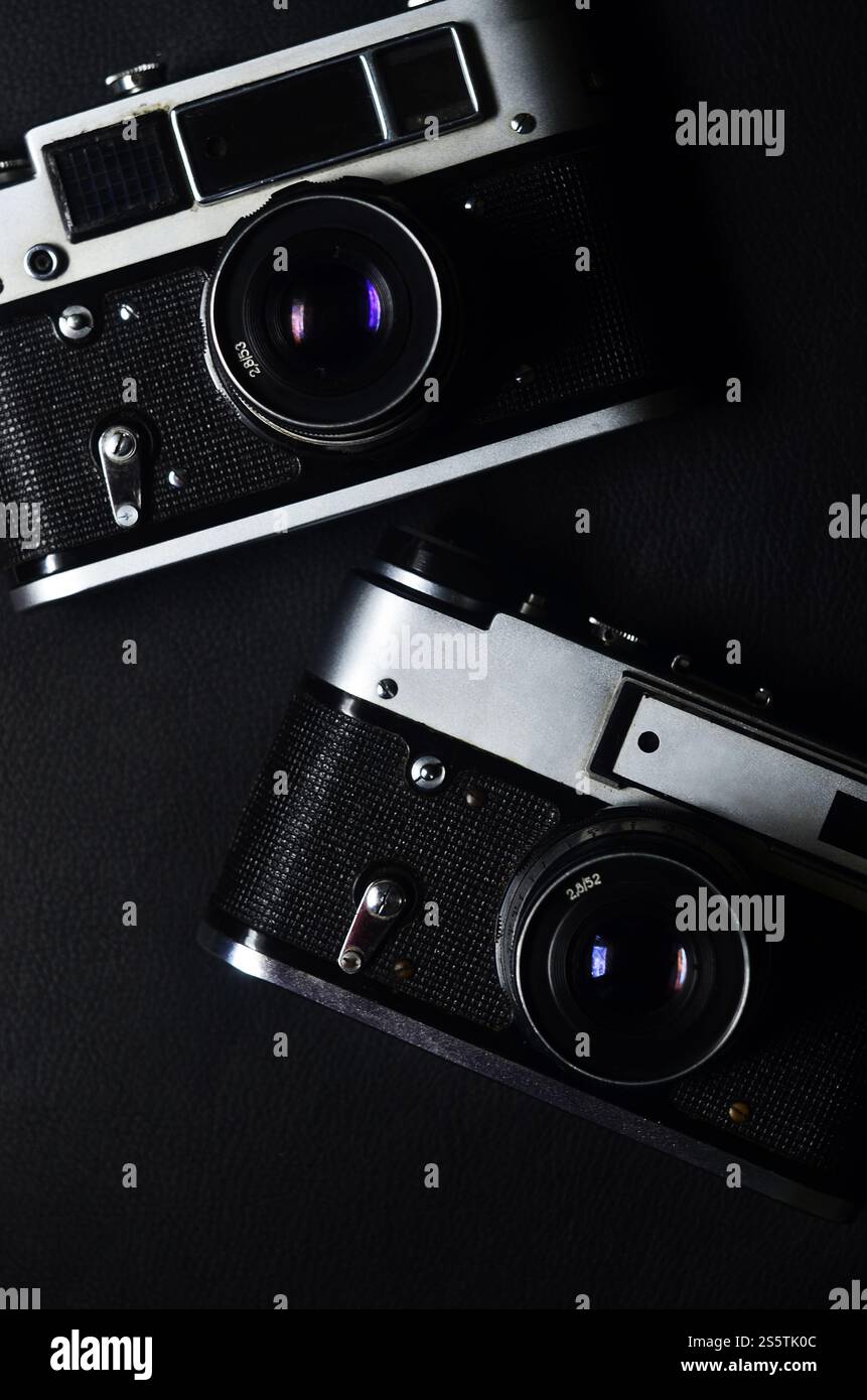 An old photo cameras from mid of 20th century on black leather ...