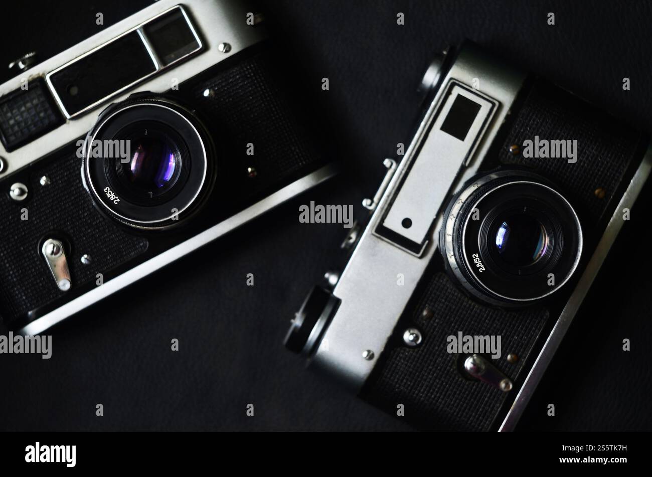 An old photo cameras from mid of 20th century on black leather ...