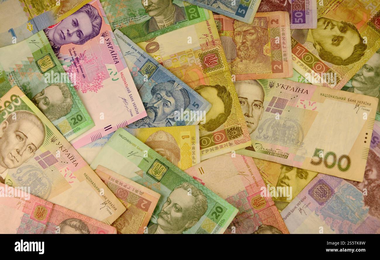The background image of a pile of Ukrainian banknotes of different ...