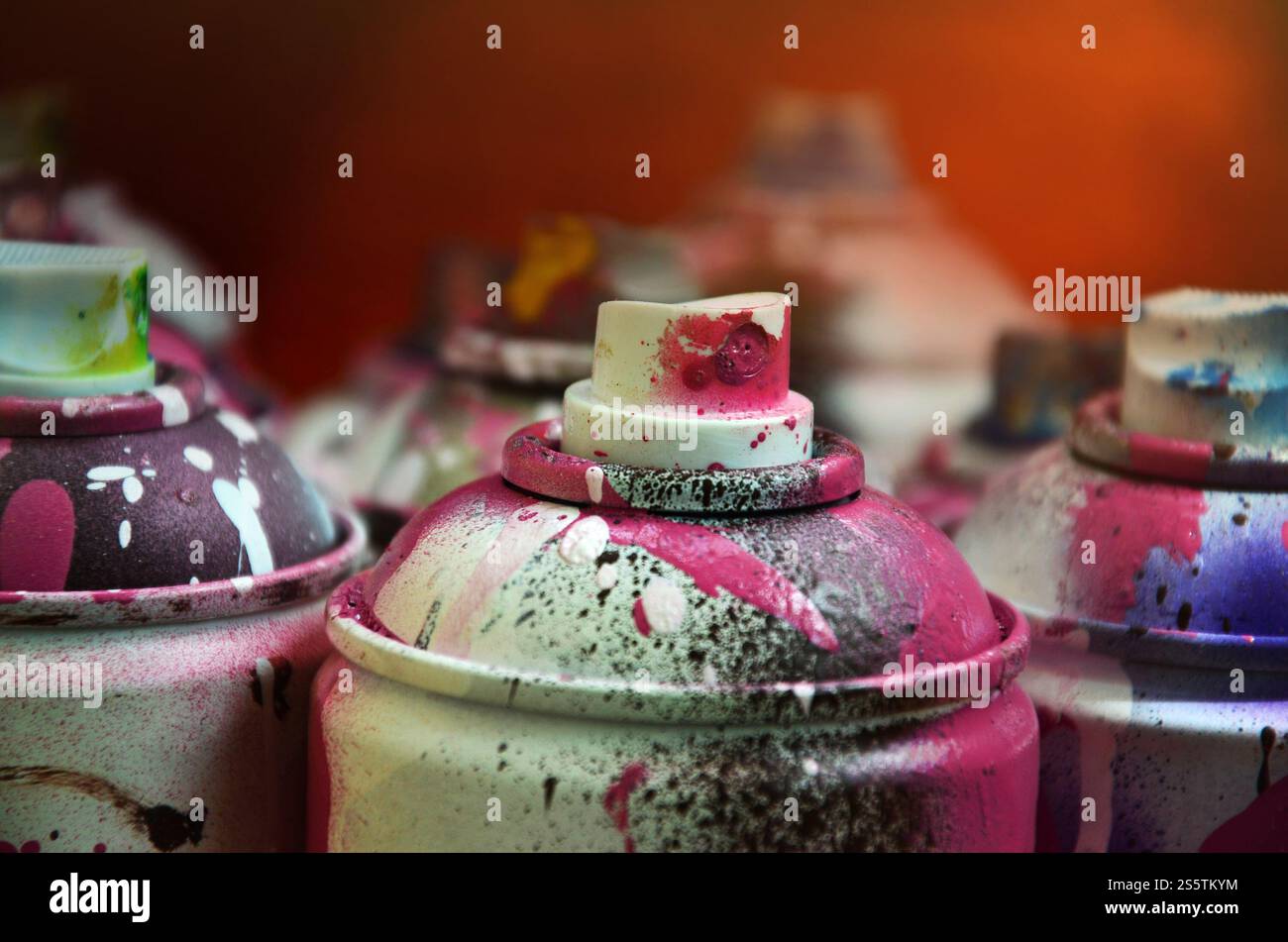 Still life with a large number of used colorful spray cans of aerosol ...