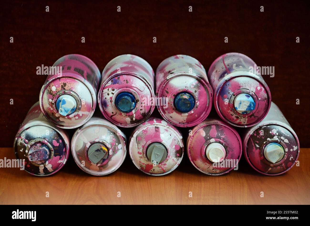 Still life with a large number of used colorful spray cans of aerosol ...