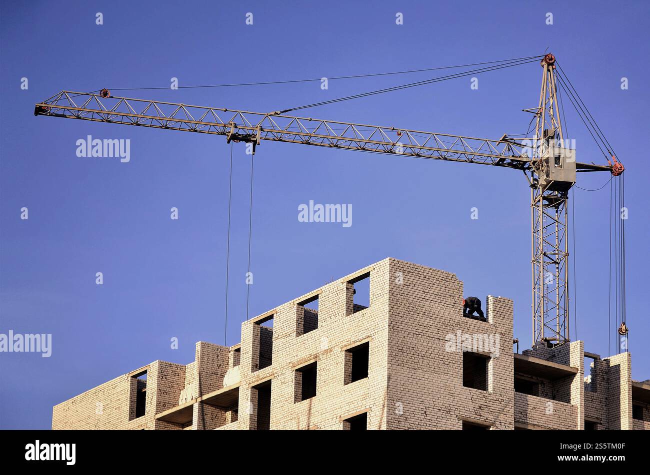Working tall cranes inside place for with tall buildings under ...