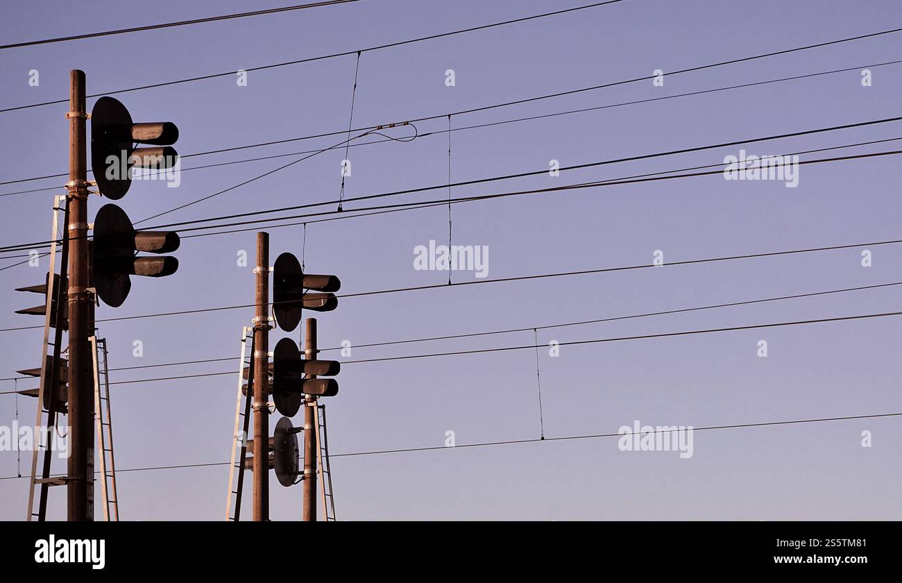 Railroad traffic light against clear blue sky, Contact wire. High ...