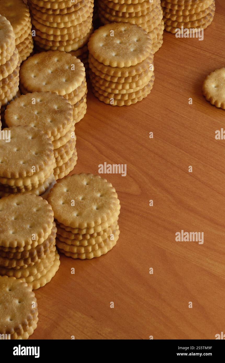 Background image of classic salty cracker on a brown wooden table with ...