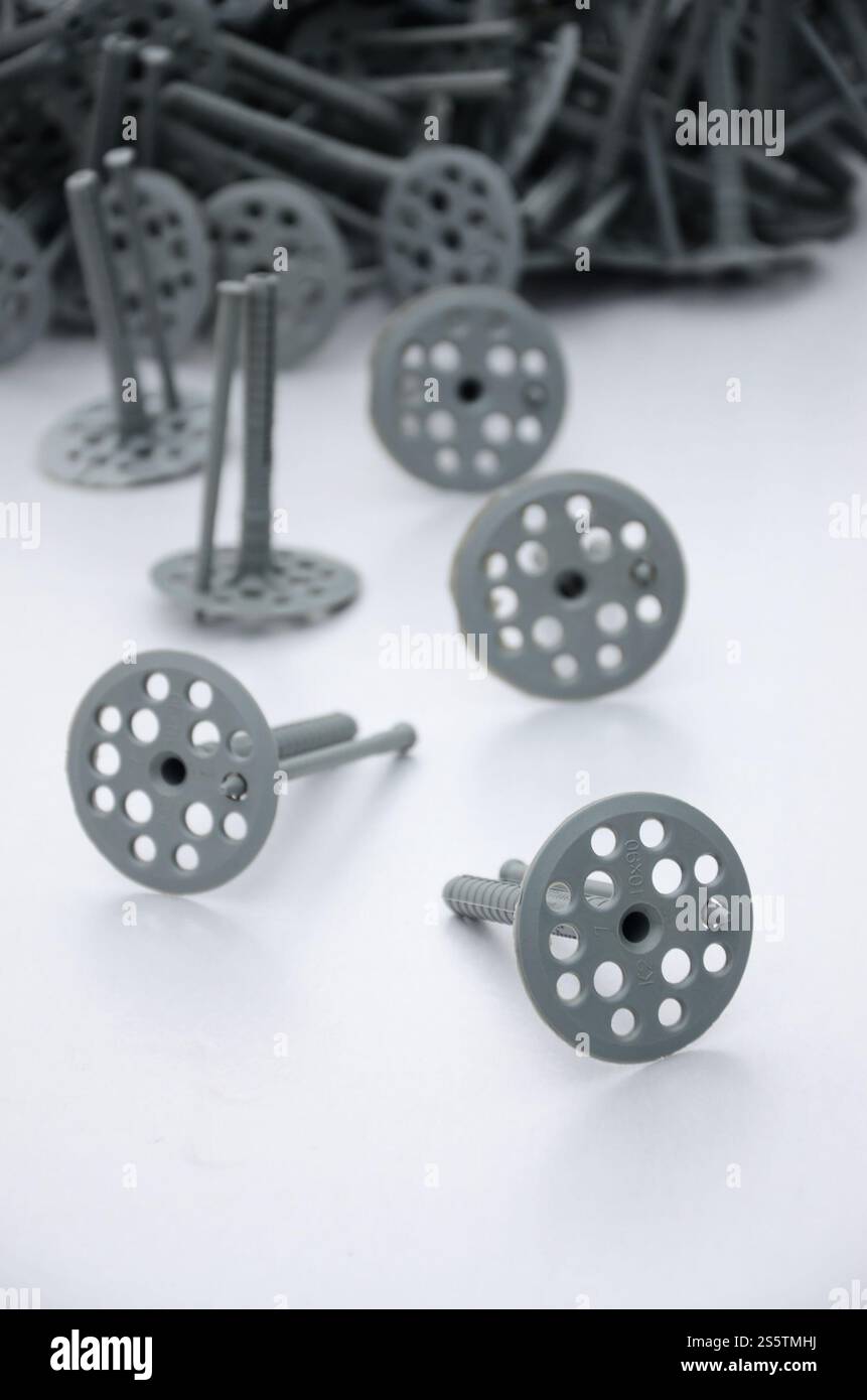 A gray plastic dowel (fastening) for thermal insulation with round ...