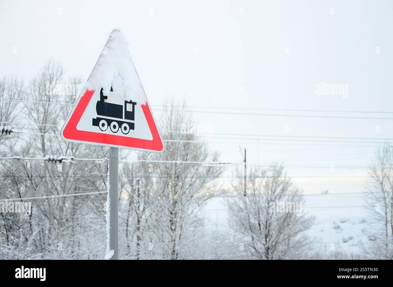 Railway crossing without barrier. A road sign depicting an old black ...