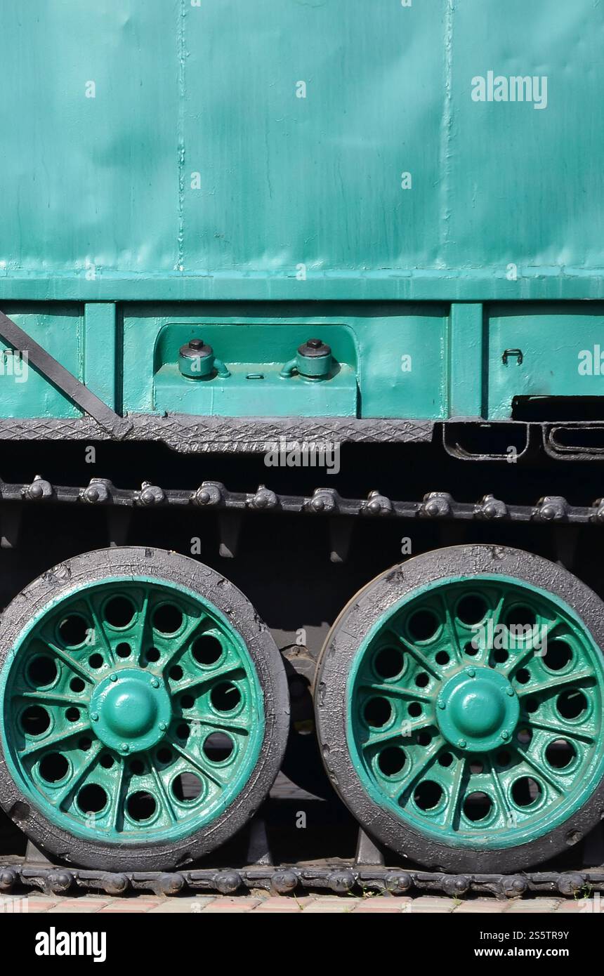 Side view of the vehicle on a caterpillar track with black tracks and ...