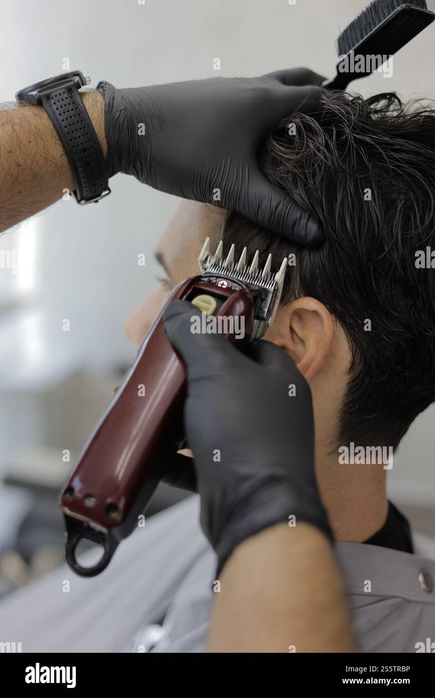 a barber is cutting customer's hair, local men's barber shop concept ...