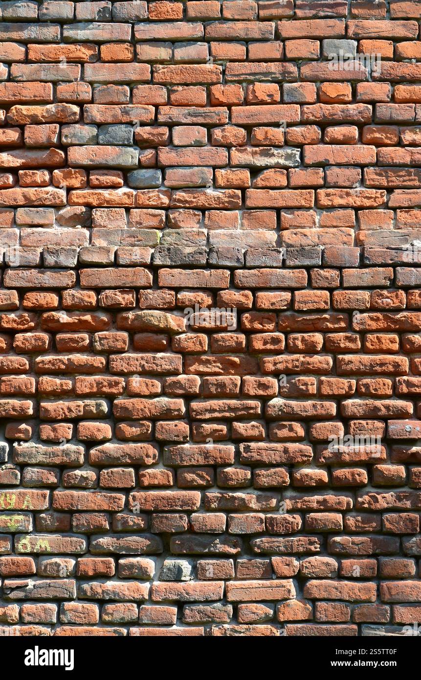 Vertical wall texture of several rows of very old brickwork made of red ...