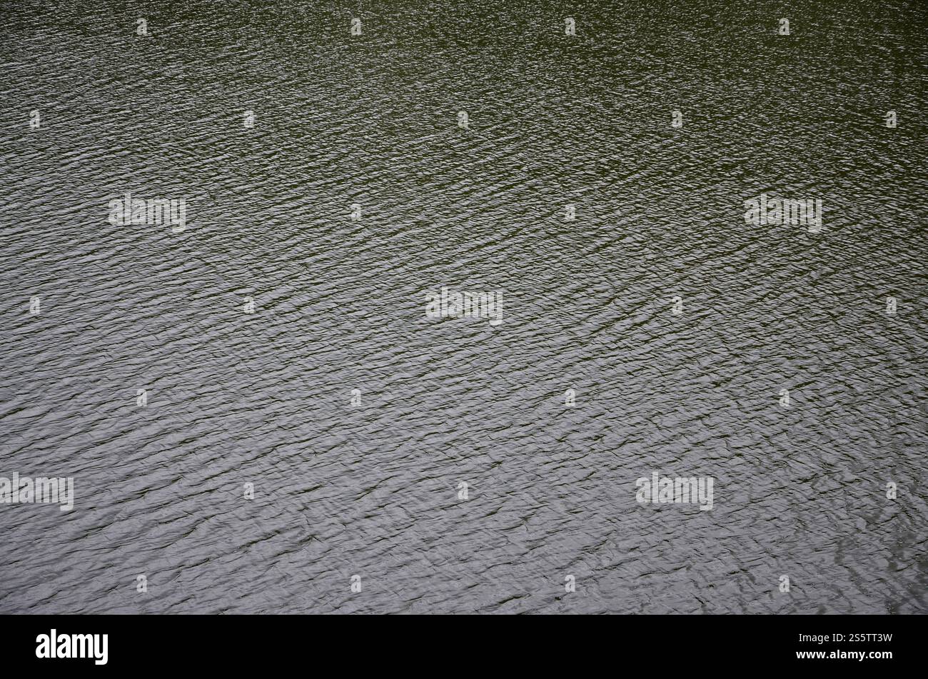 The texture of dark river water under the influence of wind, imprinted ...