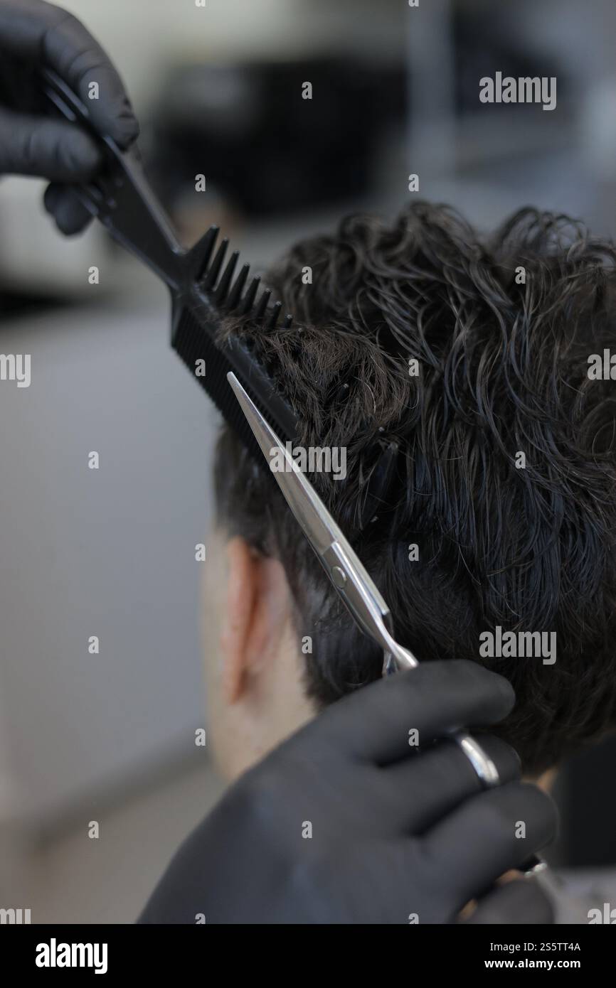 a barber is cutting customer's hair, local men's barber shop concept ...