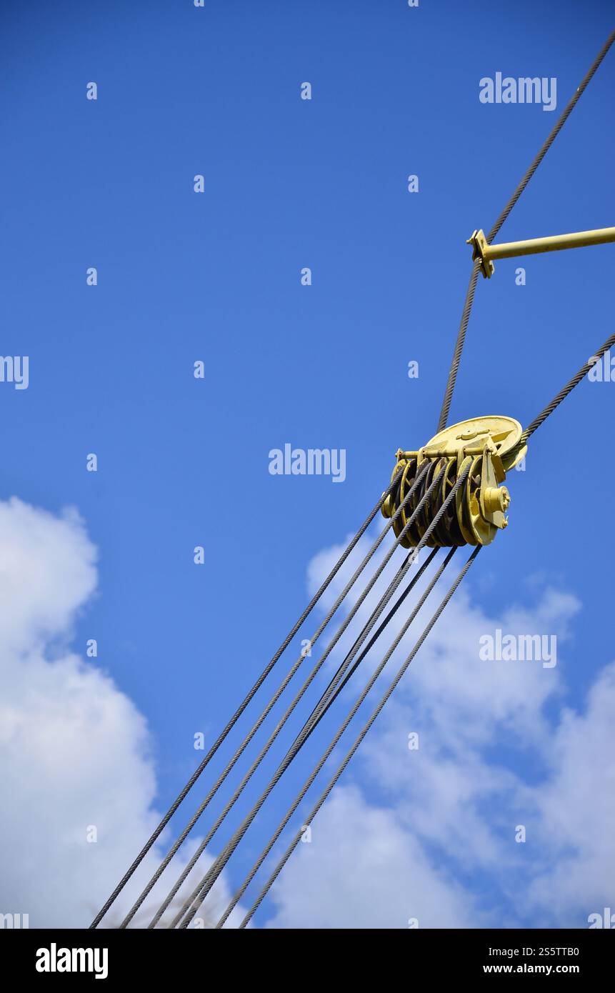 Coil for the iron cable in the tower crane against the blue sky ...