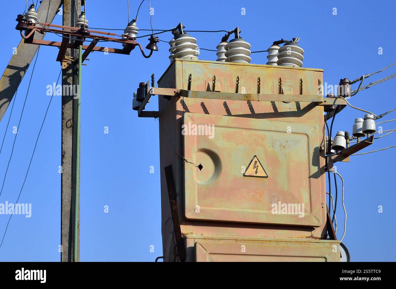 Old and obsolete electrical transformer against the background of a ...