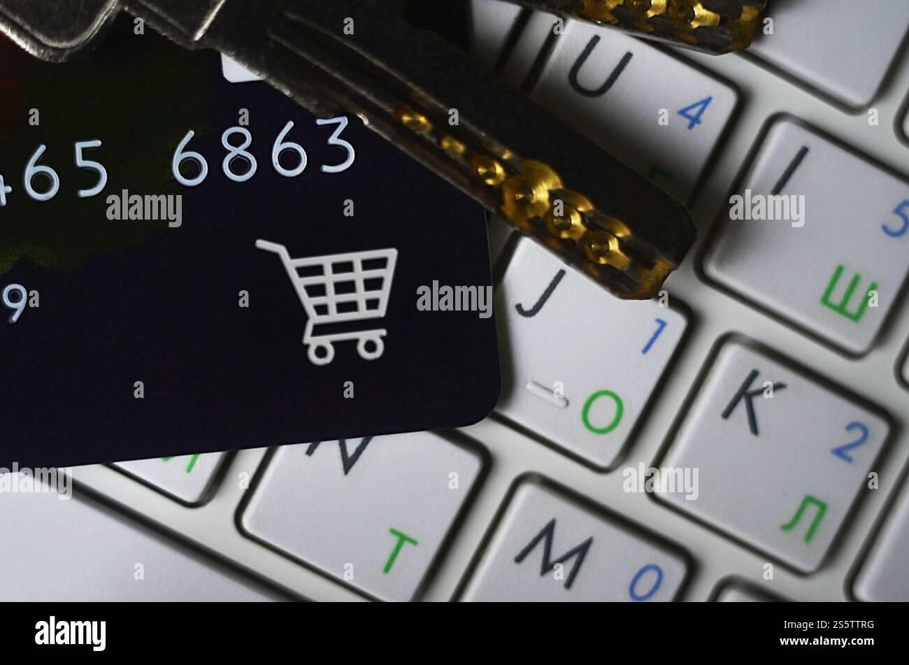 Online shopping. Credit card and keys on white laptop keyboard. E-commerce. Credit card and keys ...