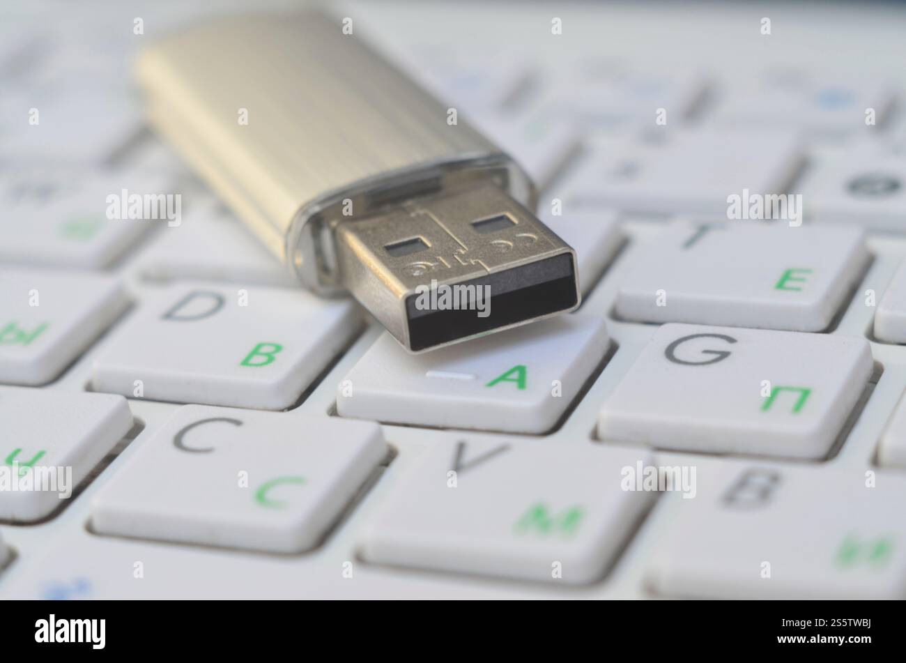 USB Flash memory card on buttons of white modern keyboard. Media ...