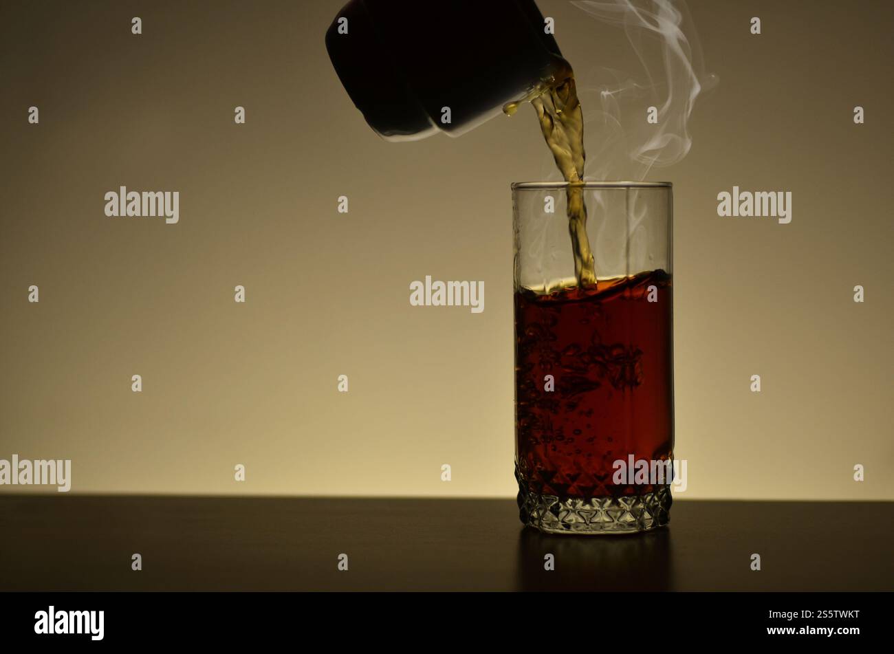 Fill the hot water cup with tea. Pouring cup of tea Stock Photo - Alamy