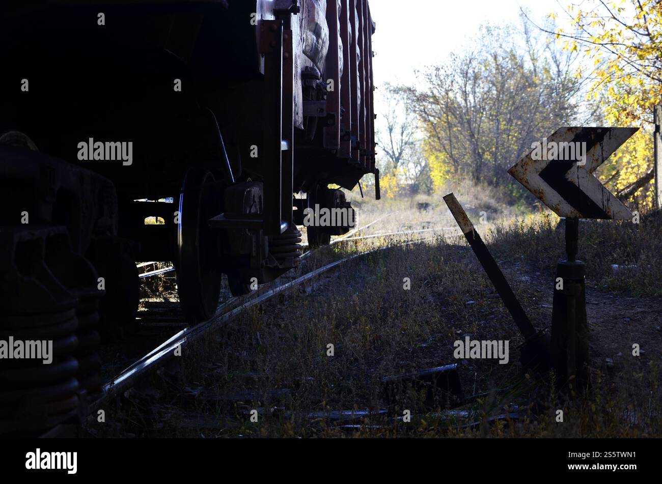Railway landscape.Railroad track switcher under the railcar dark shadow ...