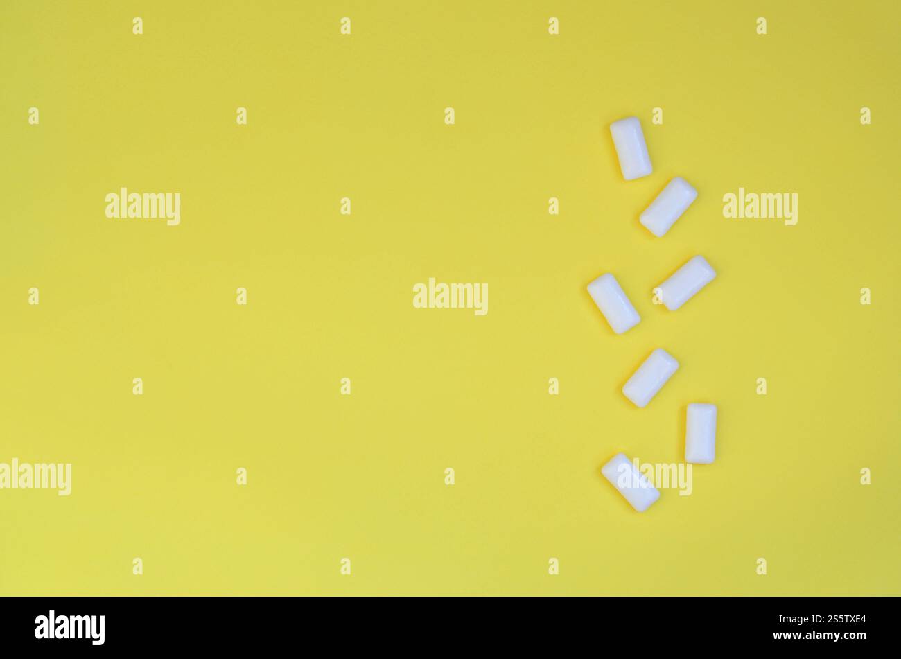 A few chewing gums lie on texture background of fashion pastel yellow ...