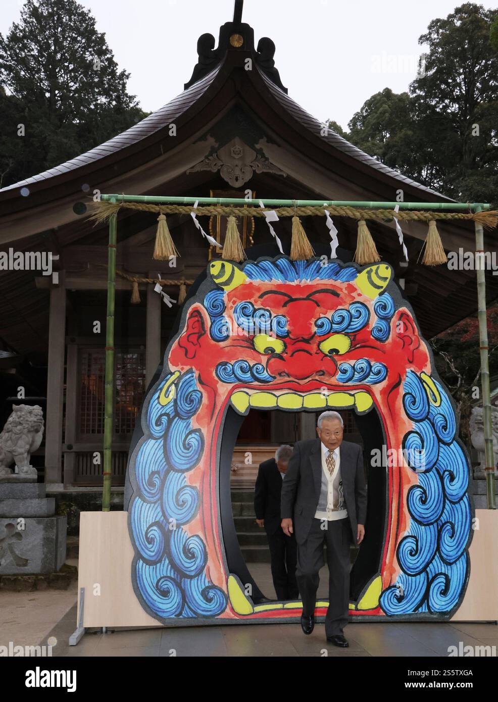 Visitors pass through the evil gate at Kamado Shrine in Dazaifu City ...