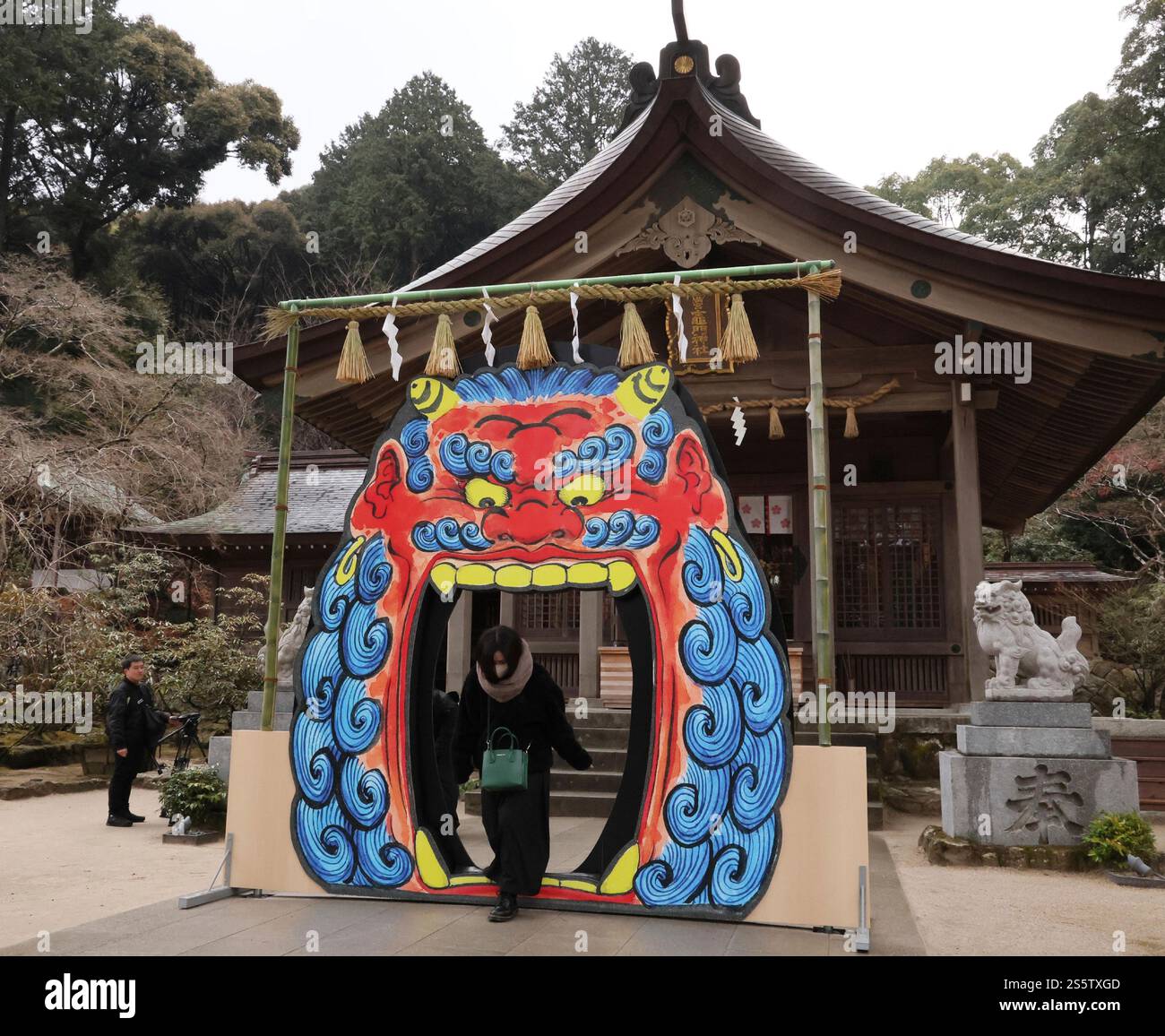 Visitors pass through the evil gate at Kamado Shrine in Dazaifu City ...