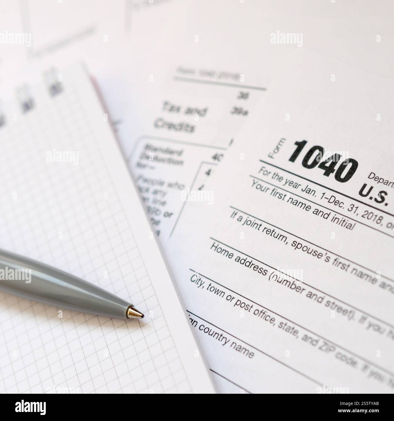 The pen and notebook is lies on the tax form 1040 U.S. Individual ...