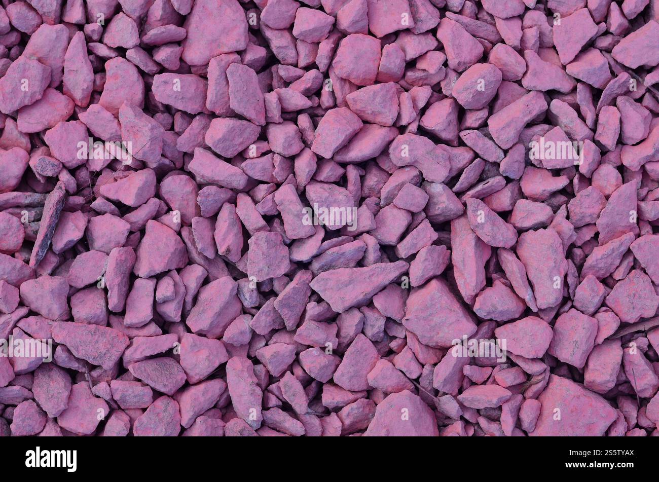 Texture from a pile of crushed stone, painted in light pink color ...