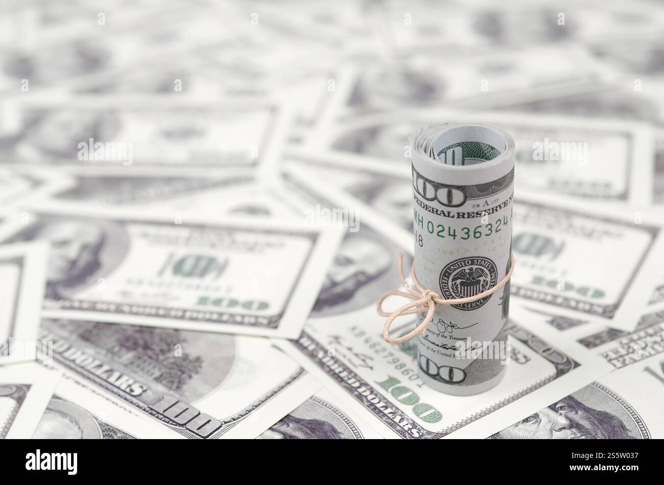 US dollars rolled up and tightened with band lies on a lot of american ...
