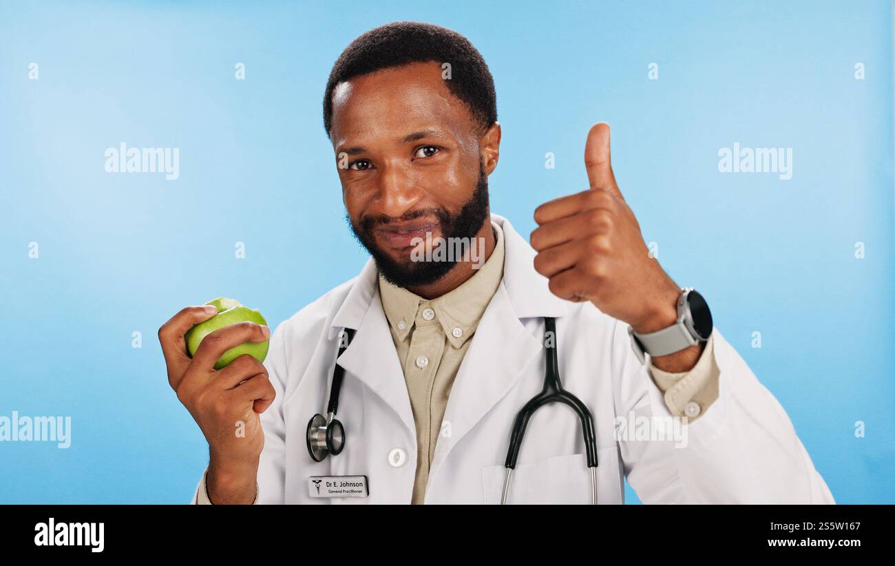Thumbs up, black man or doctor eating apple in portrait for fibre ...