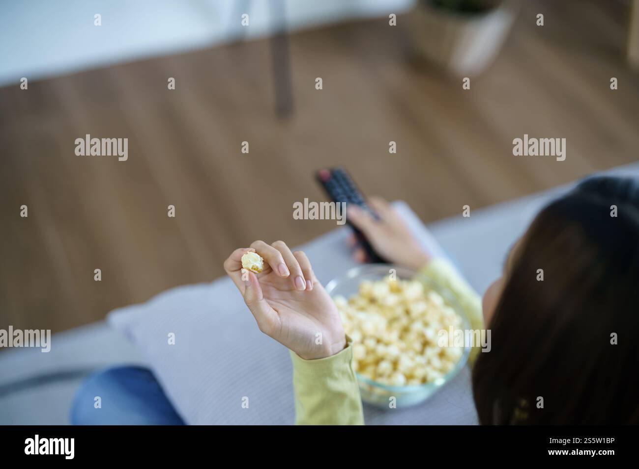 Asian woman Watching smart TV and using remote controller Hand holding ...