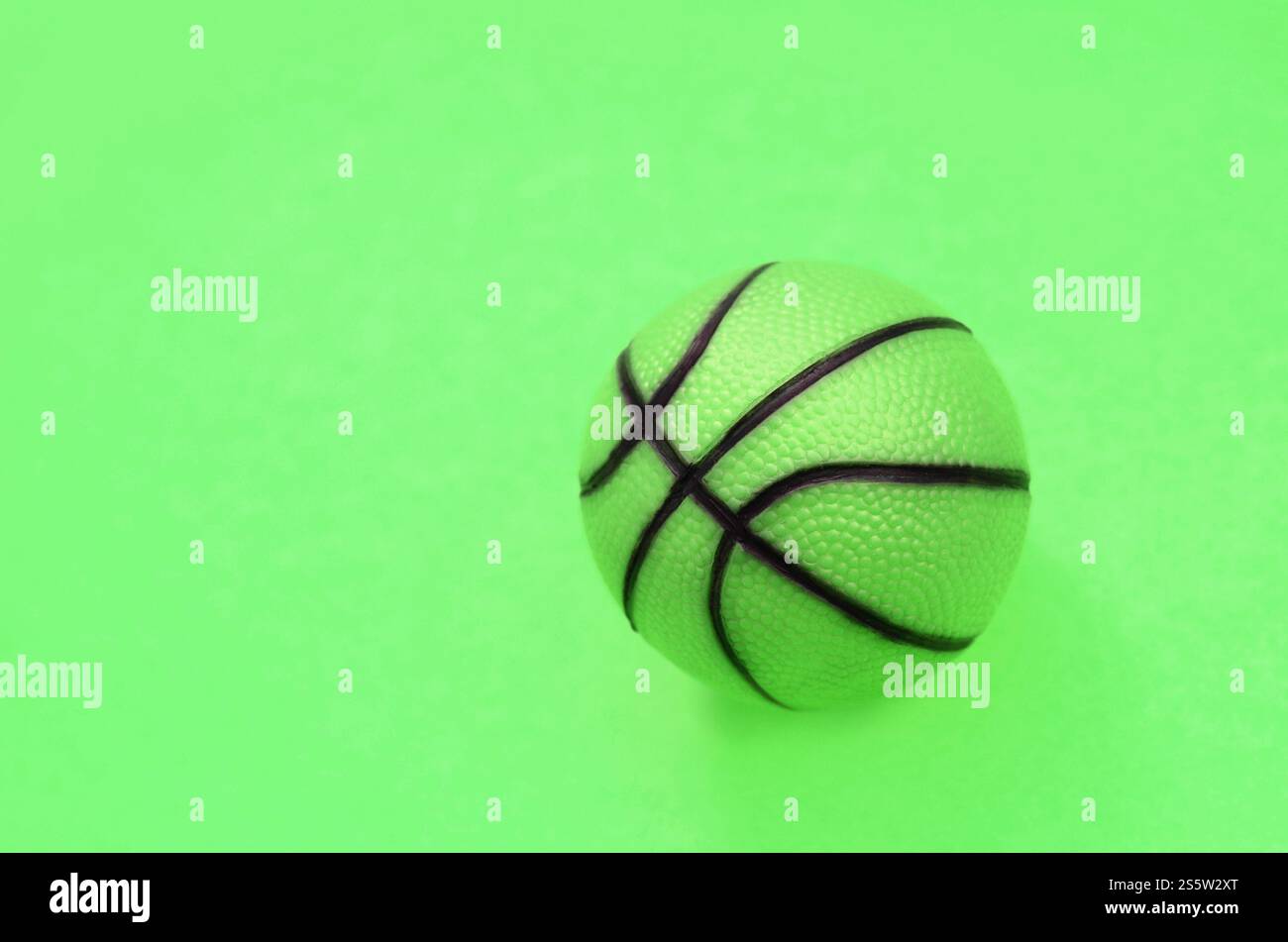 Small green ball for basketball sport game lies on texture background ...