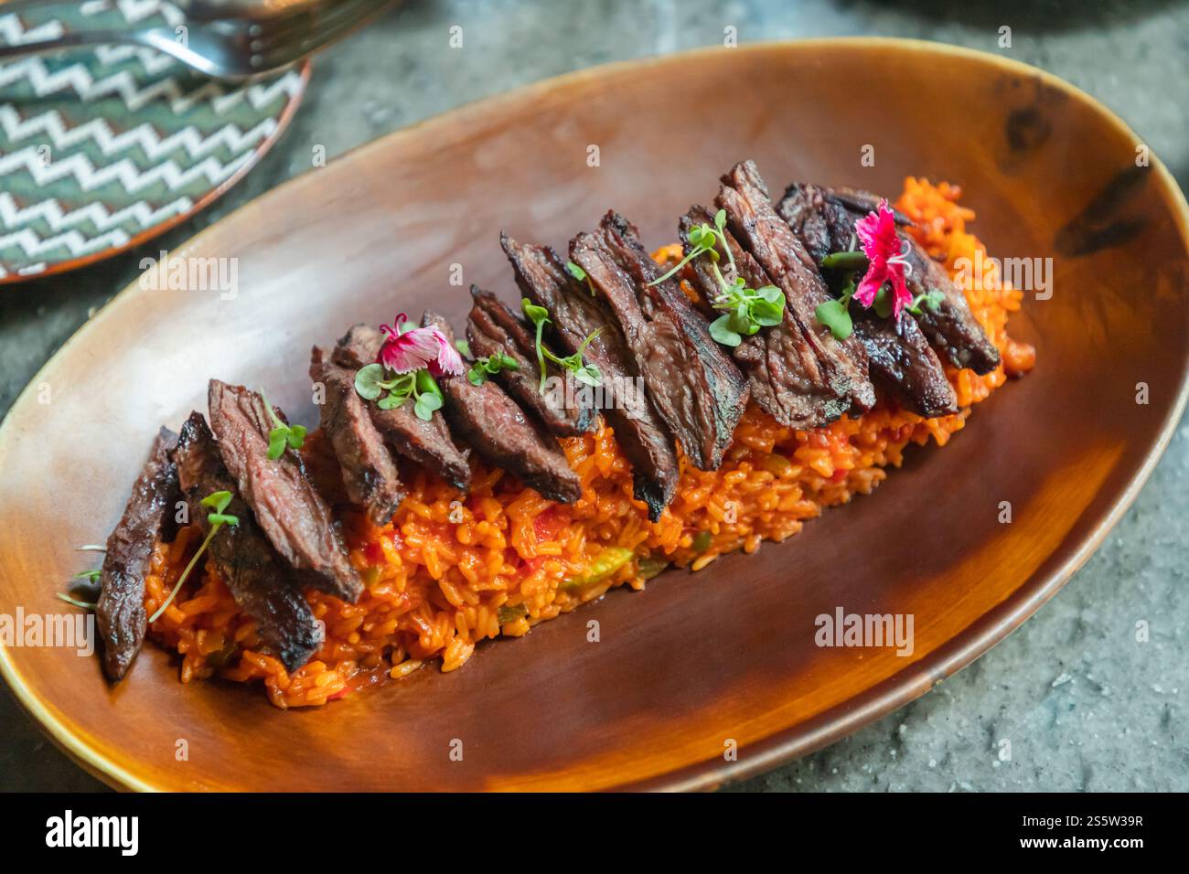 Top view churrasco angus steak over yellow rice with vegetables ...