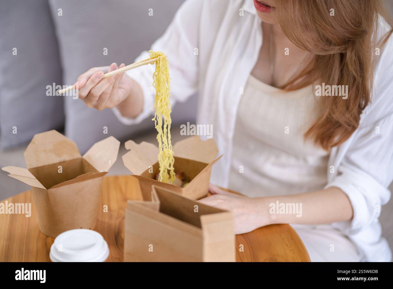 Asian woman with takeaway food and drinks at home. consumption eating ...
