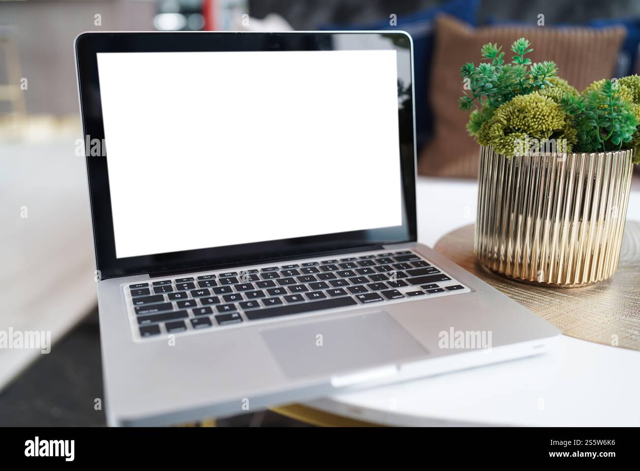 Laptop with Mock up blank screen on table in front of cafe space for ...