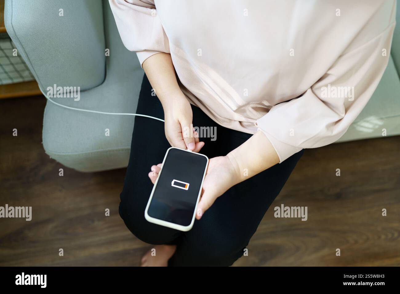 Woman hands Charging mobile phone battery with low battery. plugging a ...