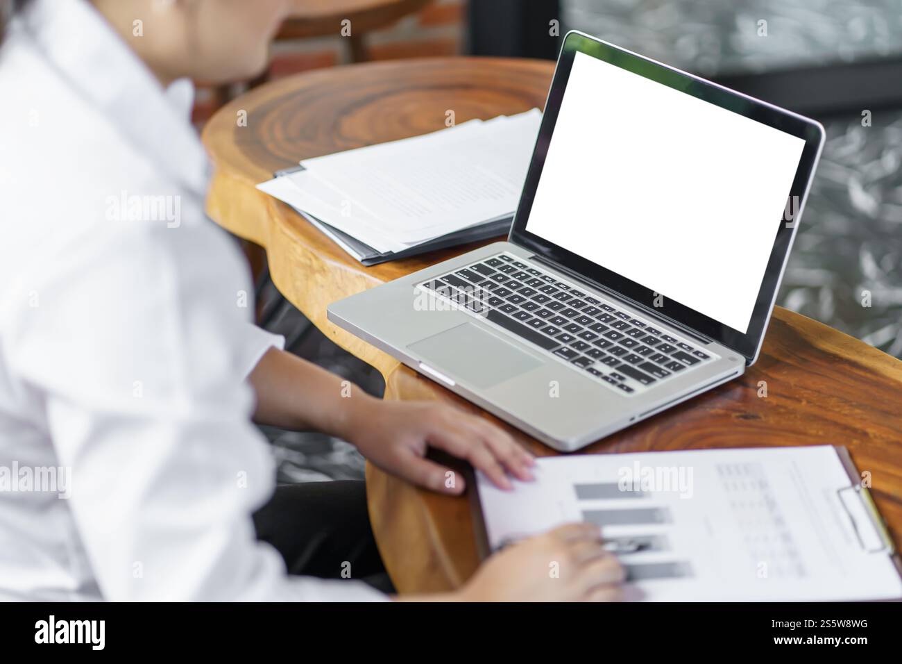 Woman Working by using laptop blank screen computer . Hands typing on a keyboard.technology e ...