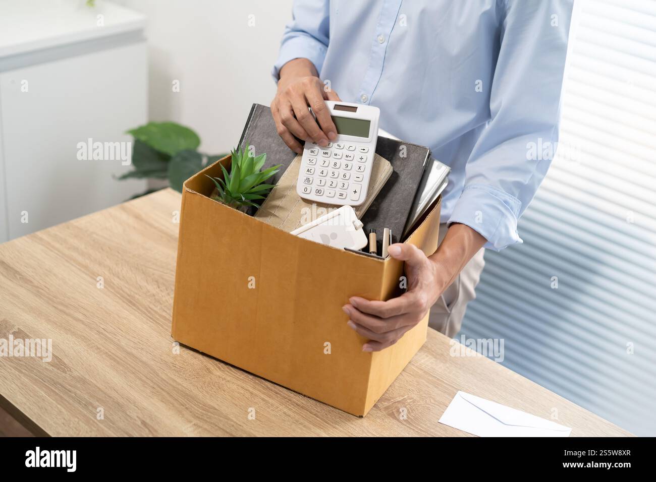 Business man sending resignation letter and packing Stuff Resign ...