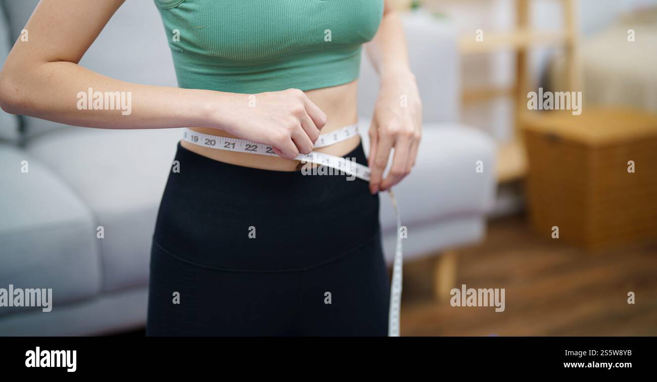 Asian woman with anorexia with measuring tape feeling unhappy. Anorexia ...