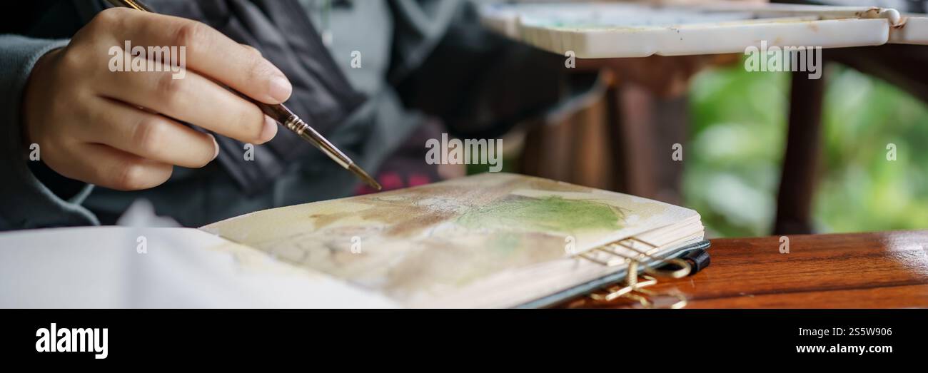 Student in classes at art studio. Hand holding artist brush mix color ...