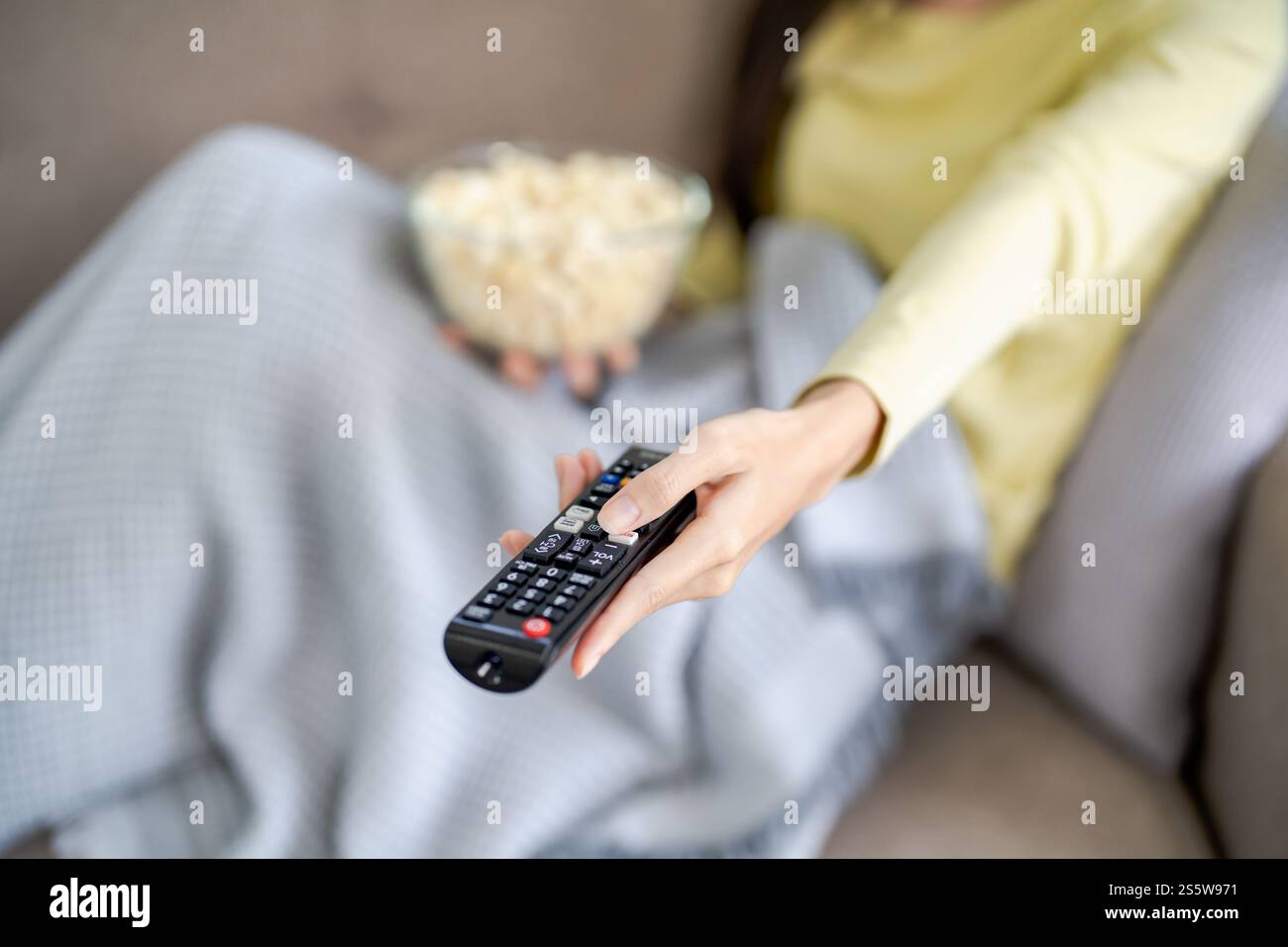 Asian woman Watching smart TV and using remote controller Hand holding ...