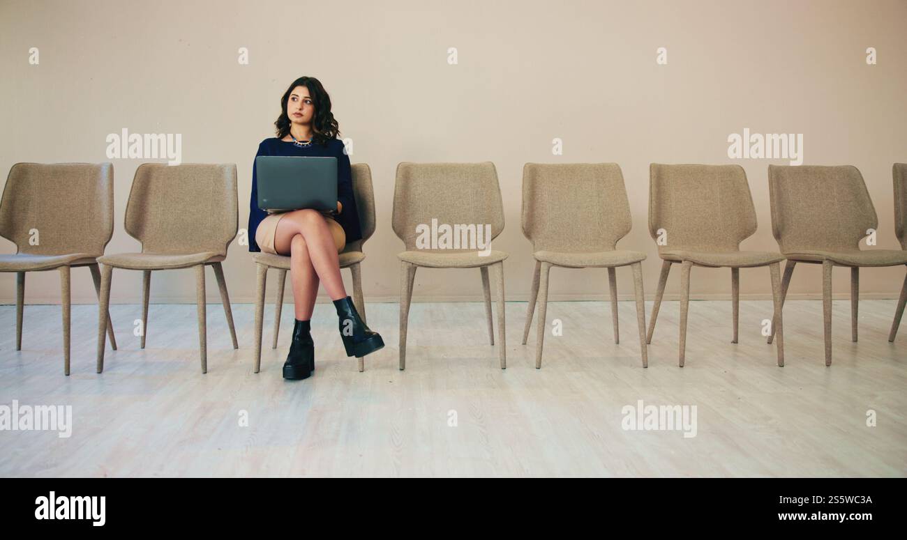 Interview, thinking and business woman on laptop in waiting room at ...