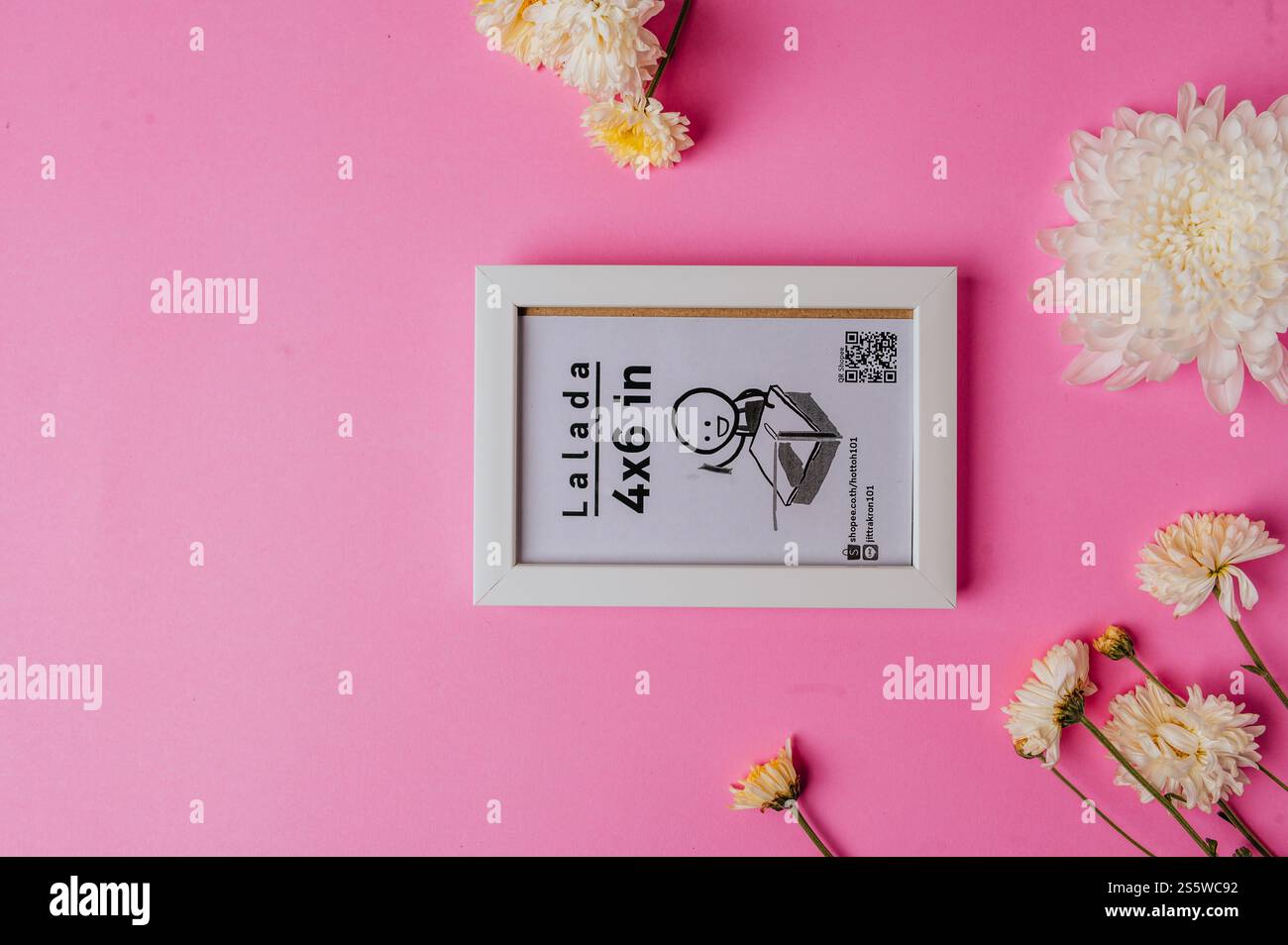 white photo frame with flower on pink background Stock Photo - Alamy