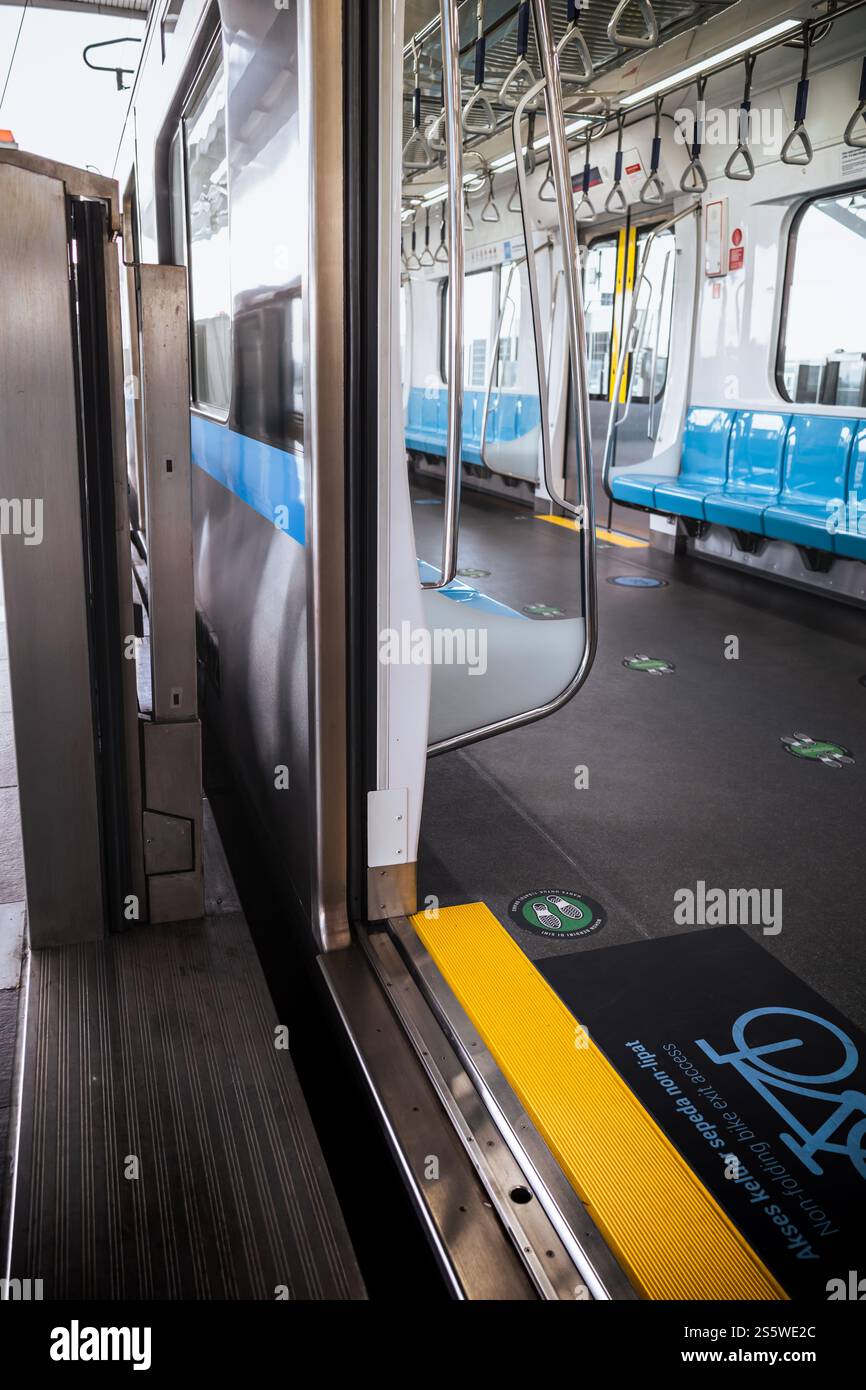 Entrance door of a subway commuter train open at station platform ...