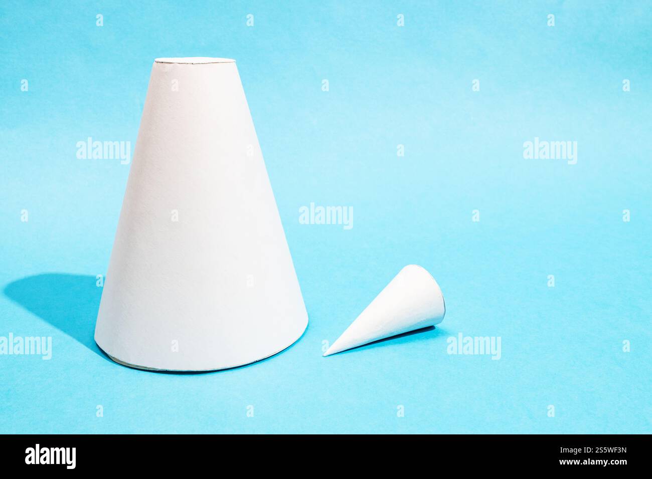 hand-crafted paper frustum cone and cone top on turquoise blue ...