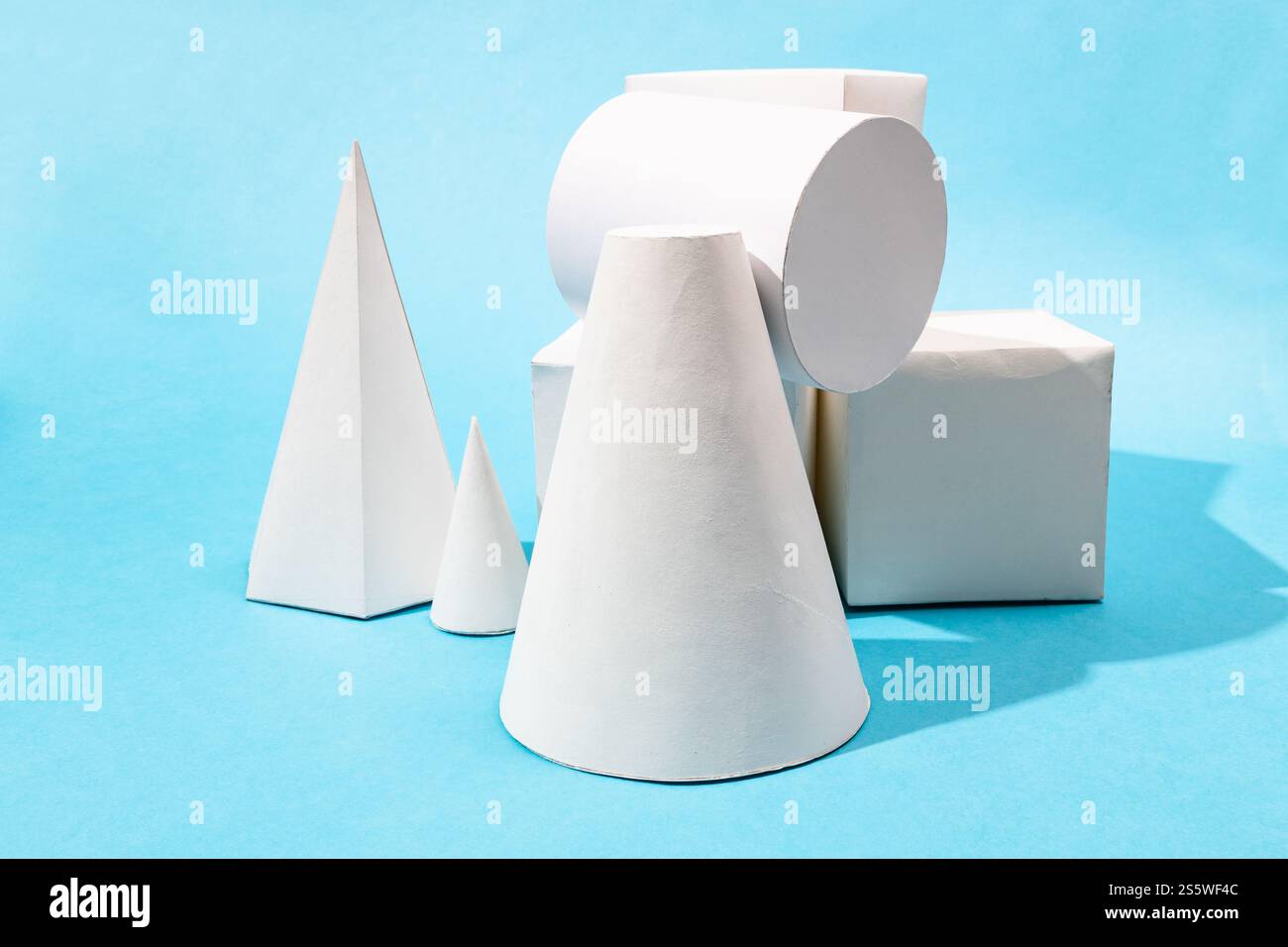 different hand-crafted paper geometric shapes on turquoise blue ...